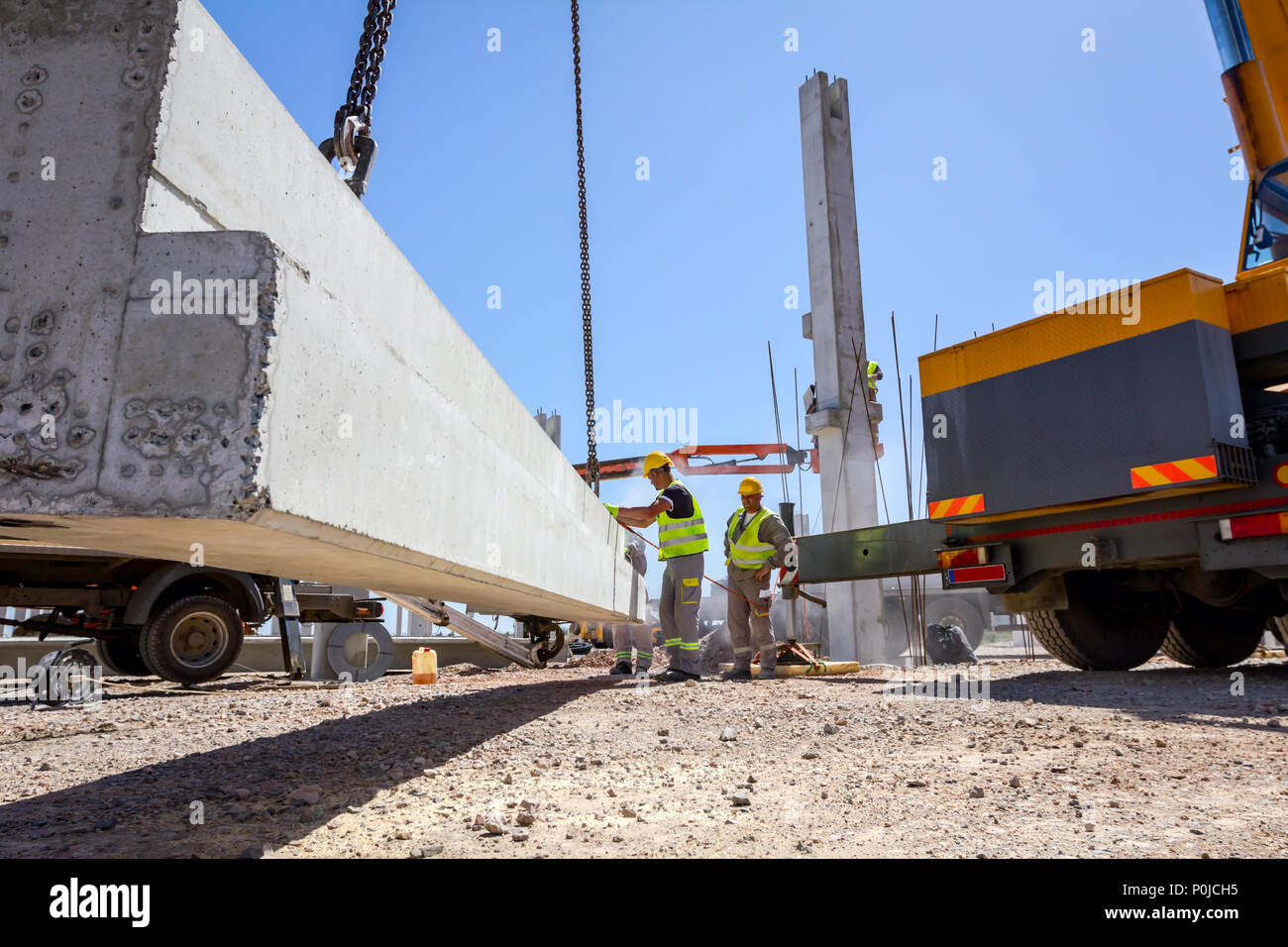 Worker is using abrasive grinding machine to set up concrete joist to ...