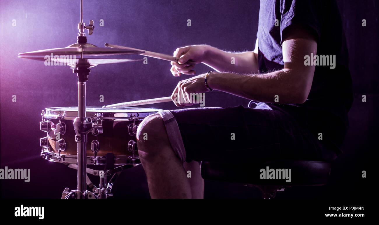 man plays musical percussion instrument with sticks, a musical concept ...