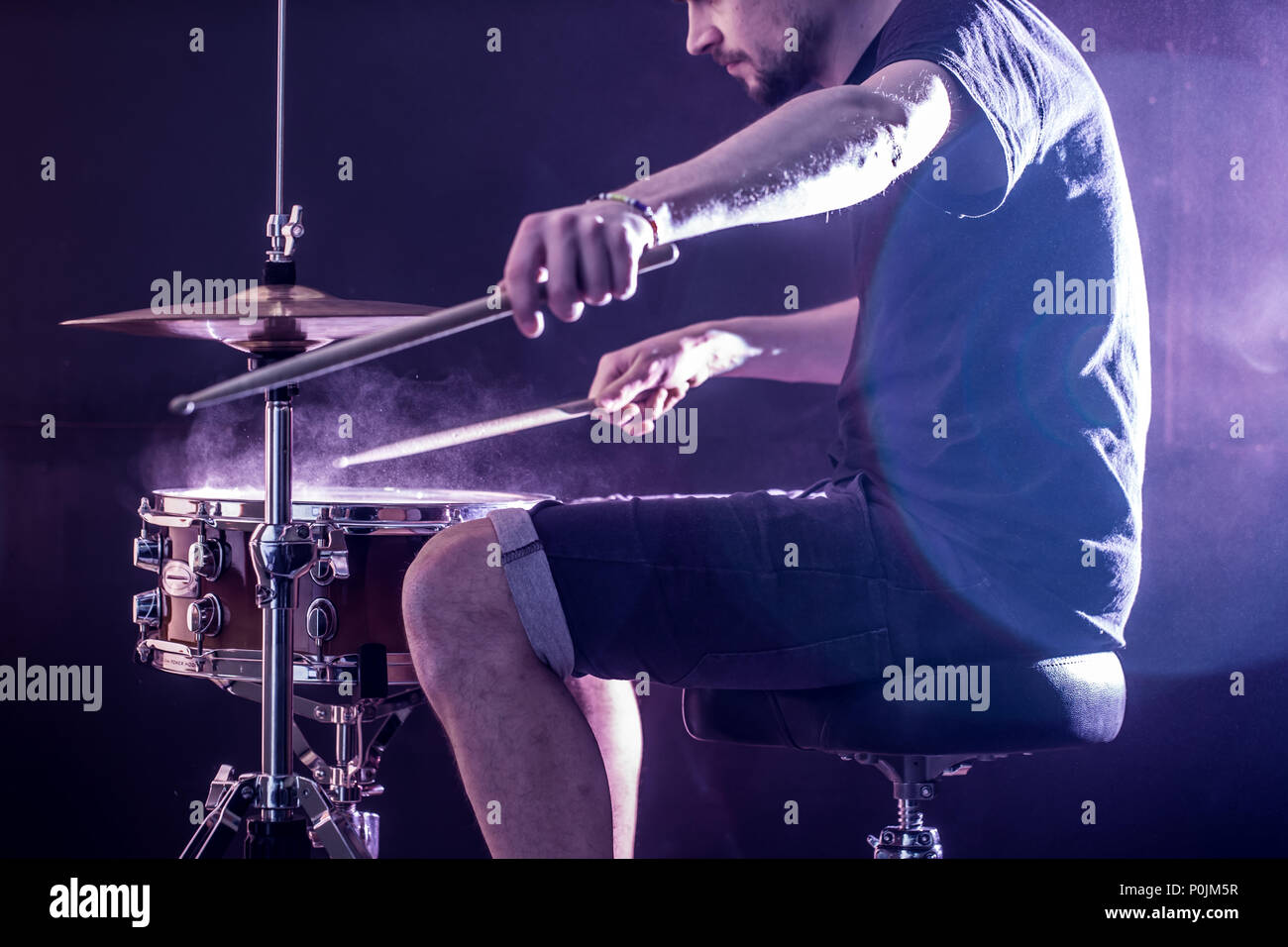 man plays musical percussion instrument with sticks, a musical concept ...