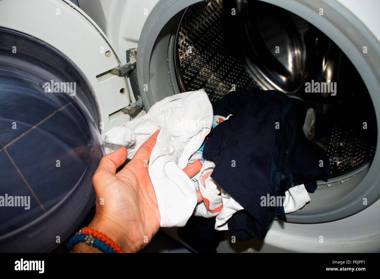 Close up woman loading clothes hi-res stock photography and images - Alamy