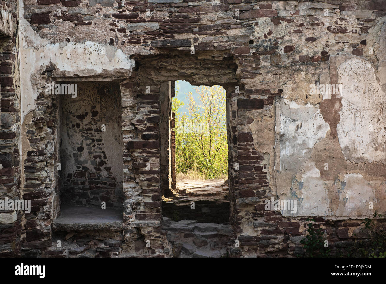 Old weathered ruined wall with breach from door, cracks and scratches ...