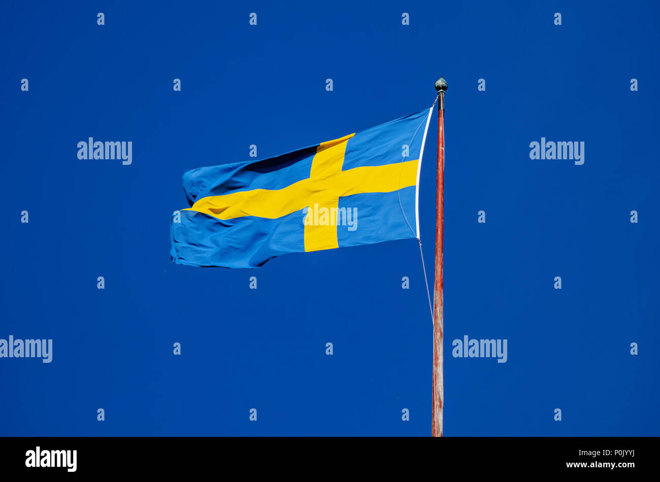 Flag of Sweden against the blue sky, national patriotic background ...