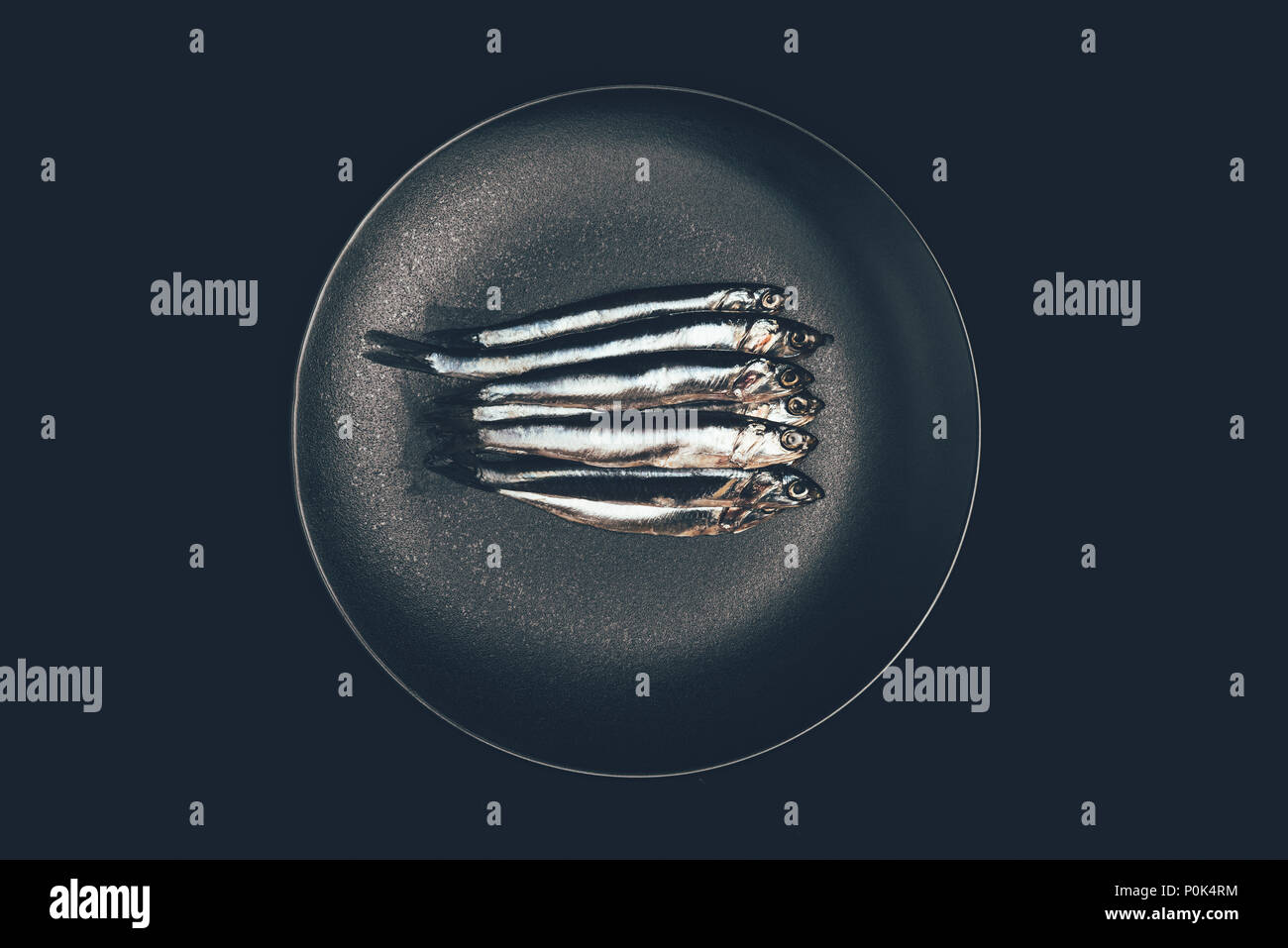 Top view of pile of fish in frying pan isolated on black Stock Photo ...