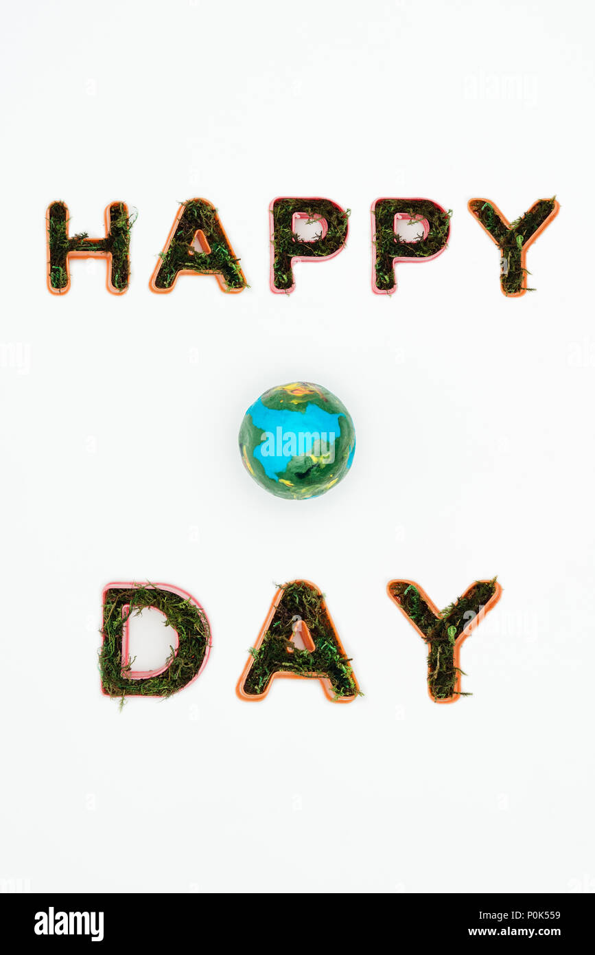 top view of earth model with text happy earth day isolated on white ...