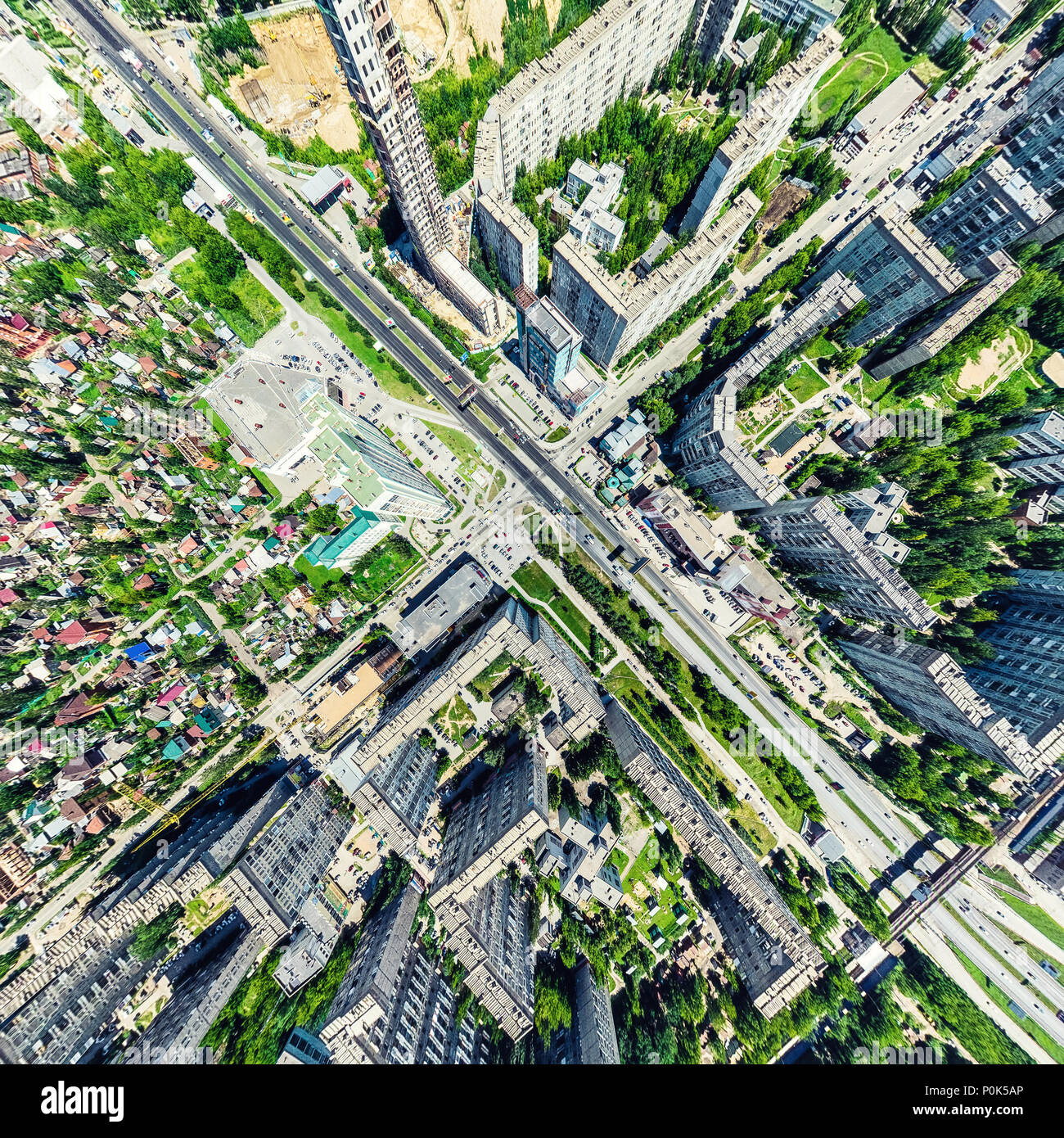 Aerial city view with crossroads and roads, houses, buildings, parks ...