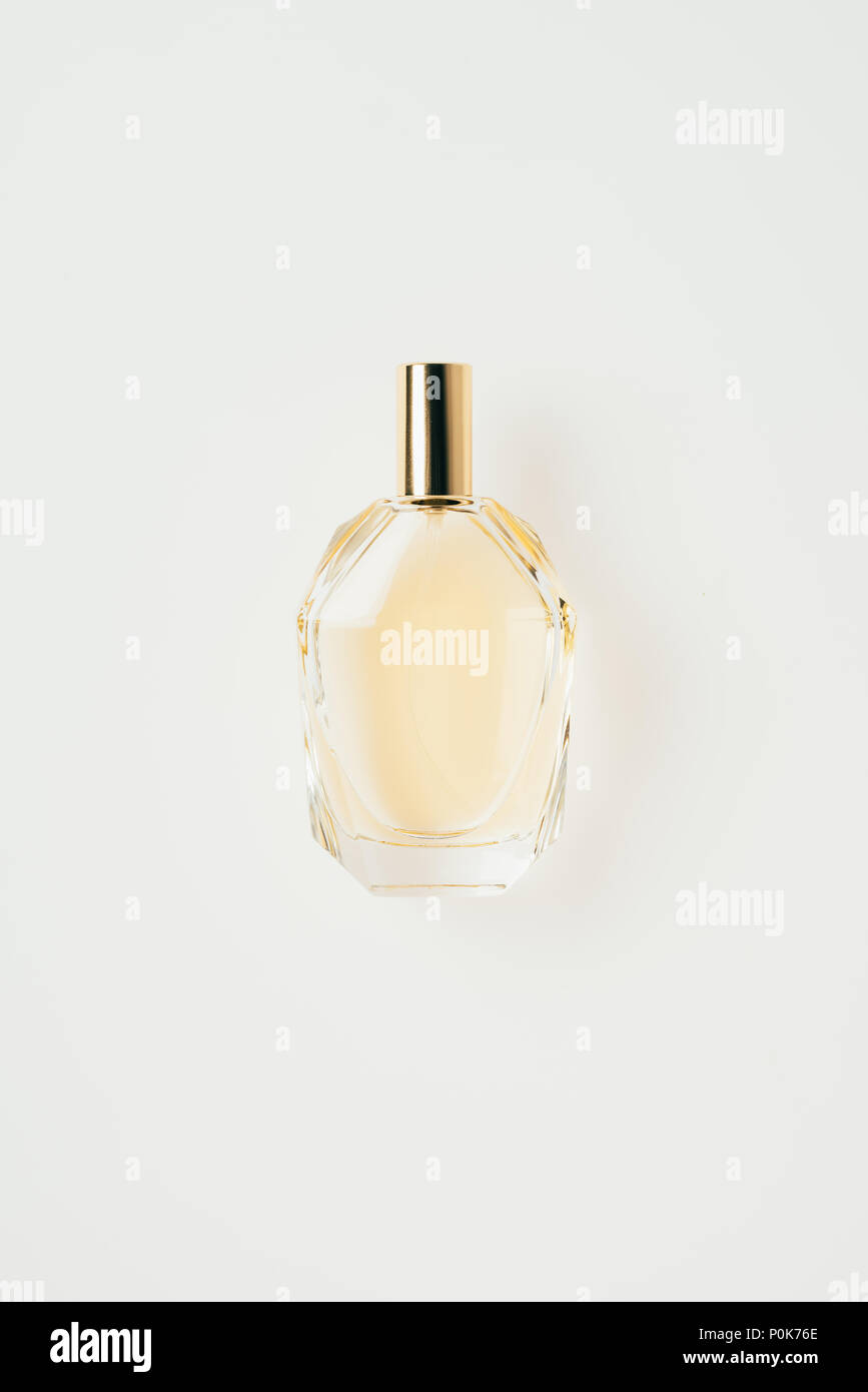 top view of glass bottle of perfume on white surface Stock Photo - Alamy