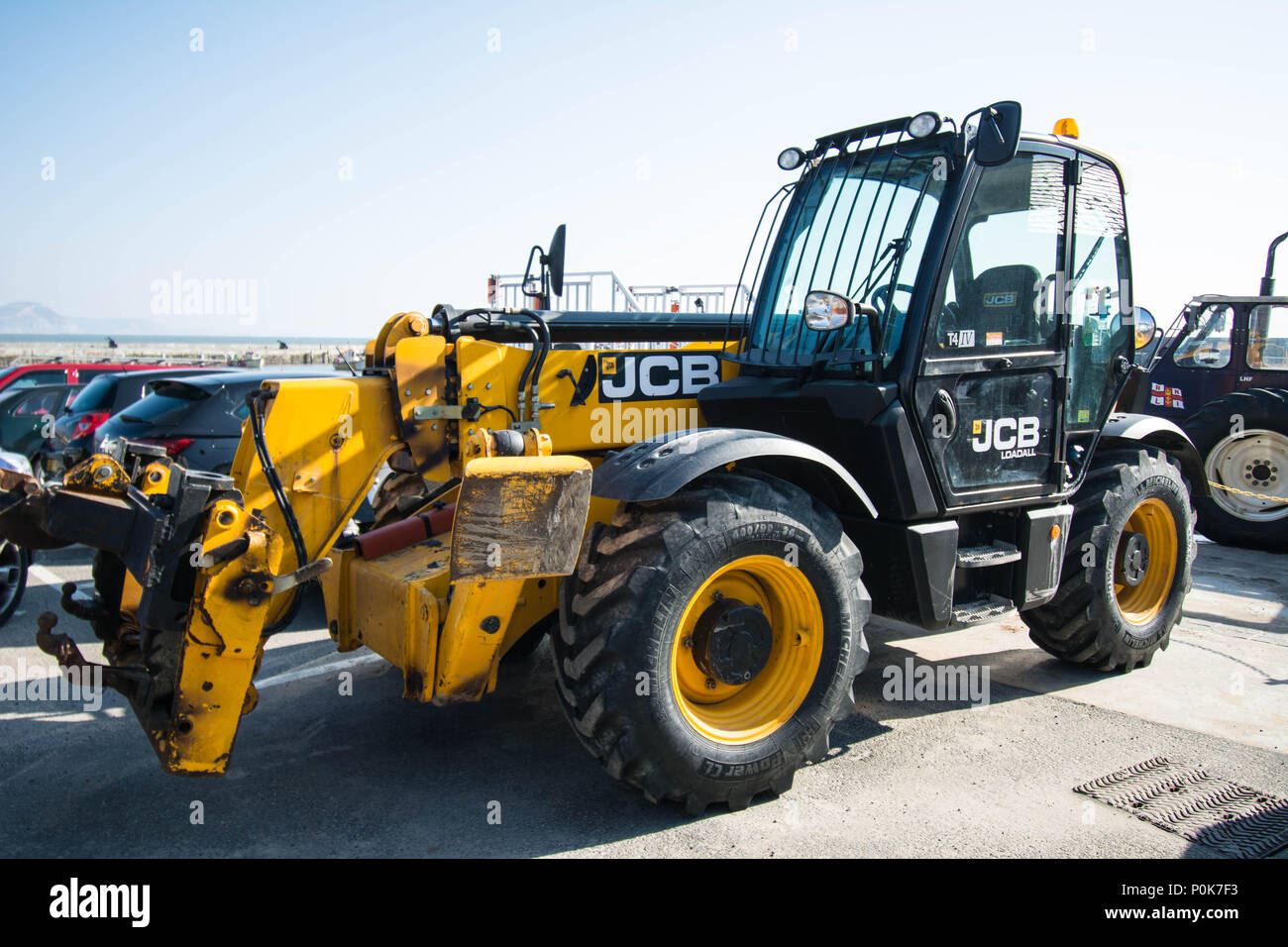 JCB digger in Lime Regis Uk England spade big large machine yellow road ...