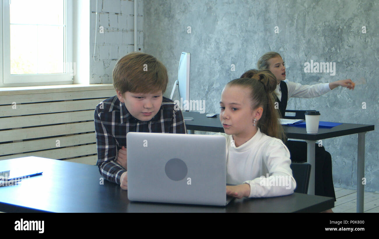 Little office kids working with documents and laptop computer in office ...