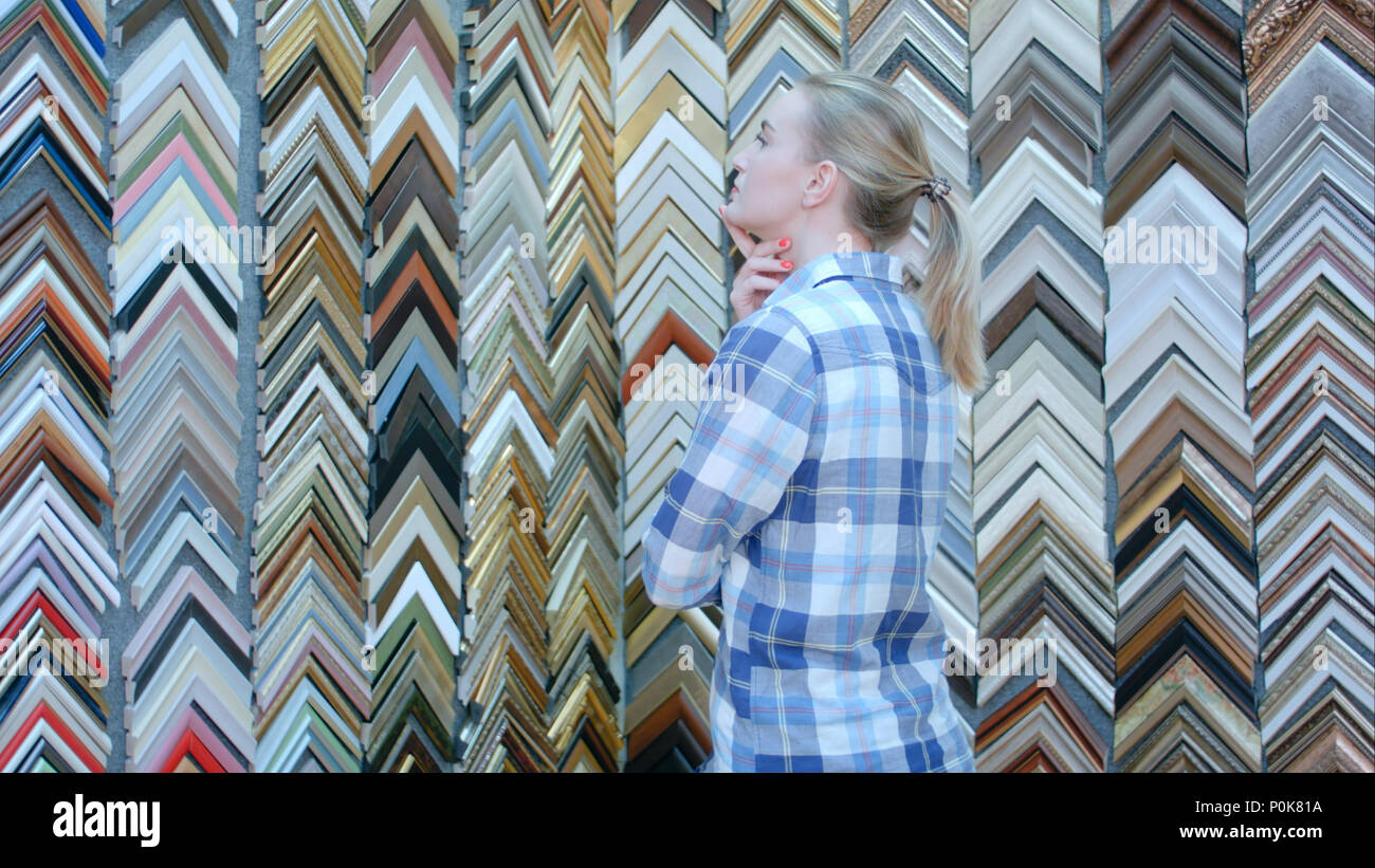 Female customer looking frame in hi-res stock photography and images ...