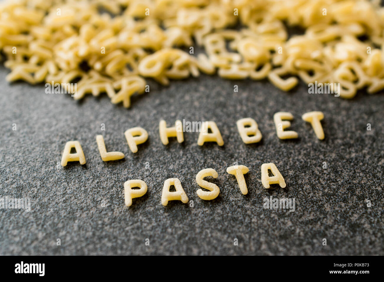 Raw Alphabet Pasta is Written with Letters on Granit Grey Surface ...