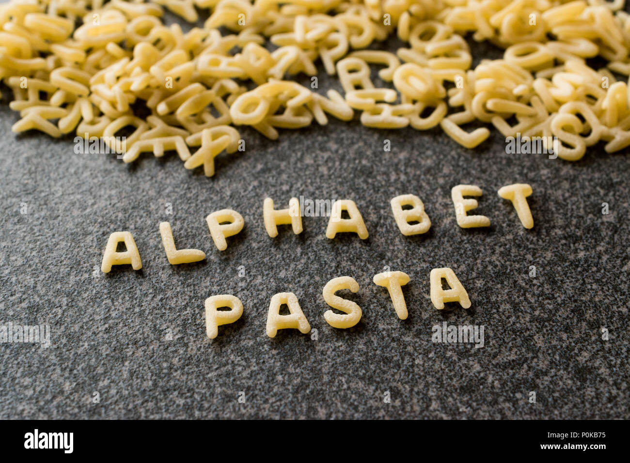 Raw Alphabet Pasta is Written with Letters on Granit Grey Surface ...