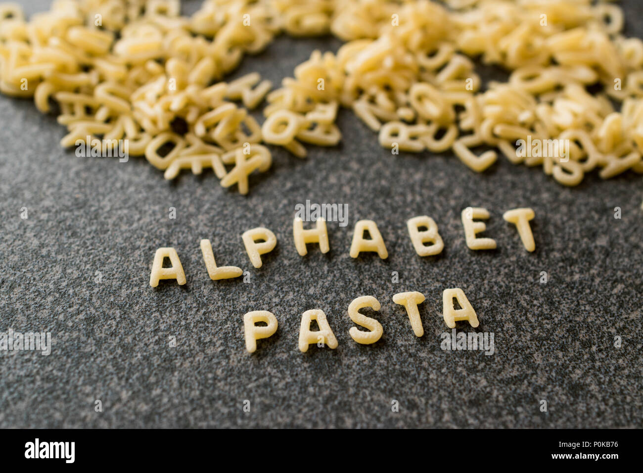 Raw Alphabet Pasta is Written with Letters on Granit Grey Surface ...