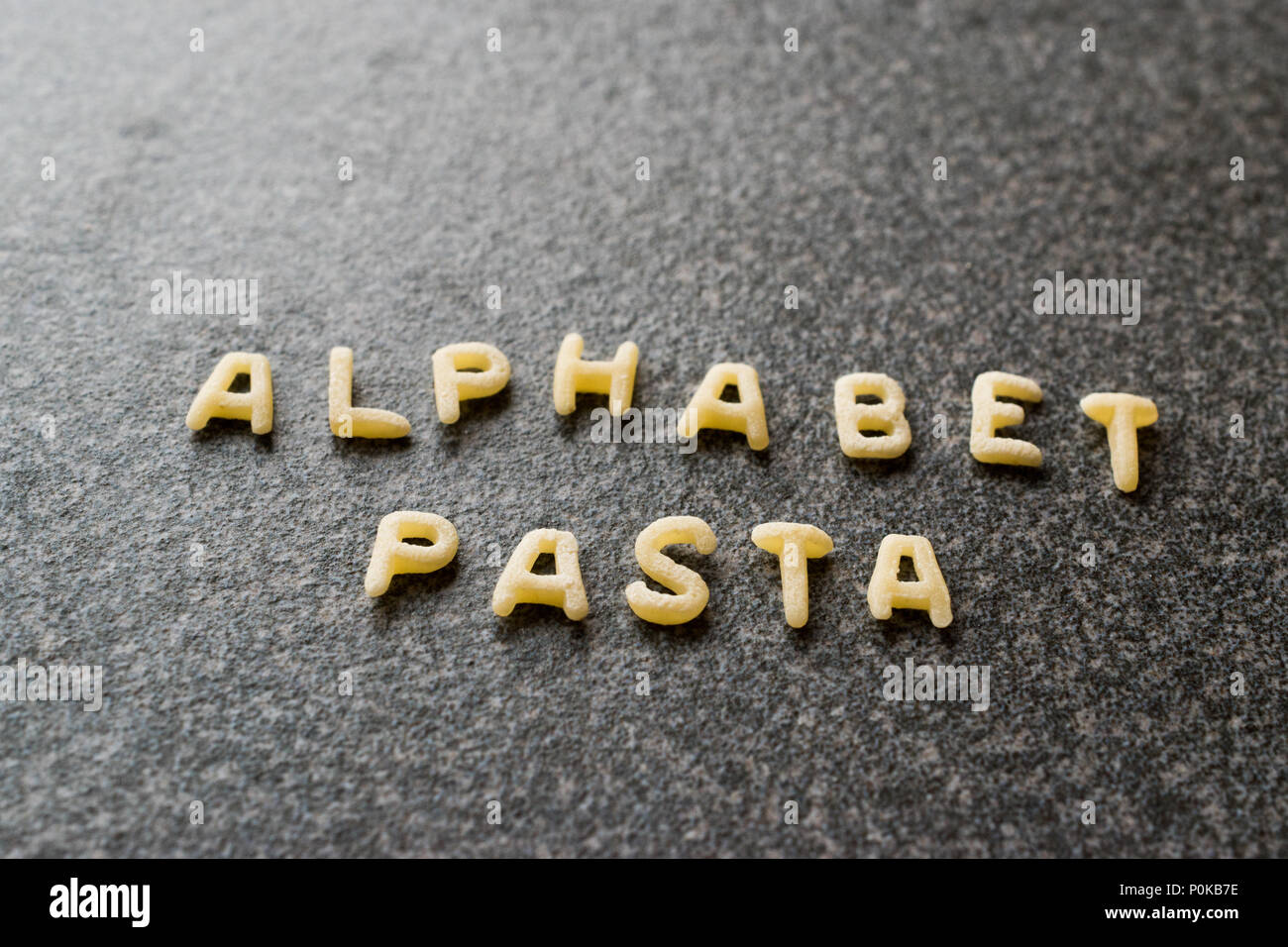 Raw Alphabet Pasta is Written with Letters on Granit Grey Surface ...