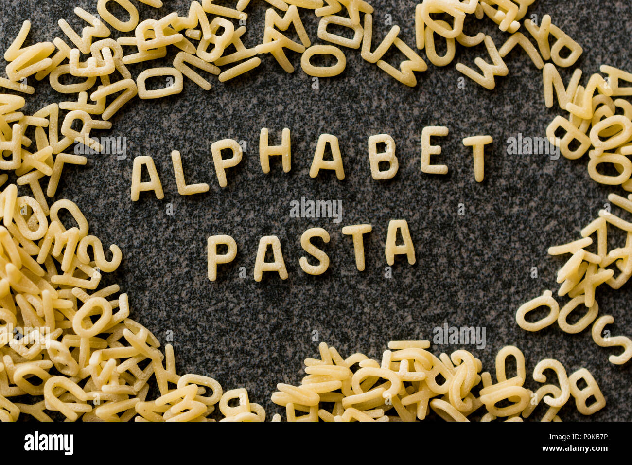 Raw Alphabet Pasta is Written with Letters on Granit Grey Surface ...