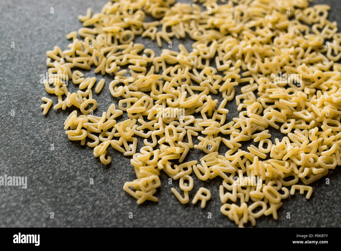 Stack of Raw Uncooked Alphabet Pasta is Written with Letters on Granit ...