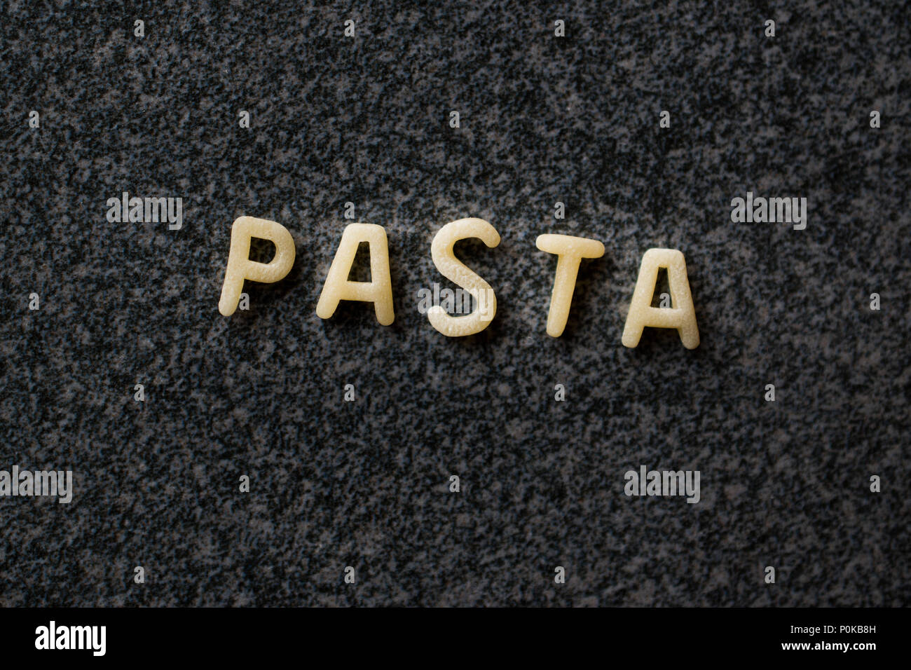 Raw Alphabet Pasta is Written with Letters on Granit Grey Surface ...