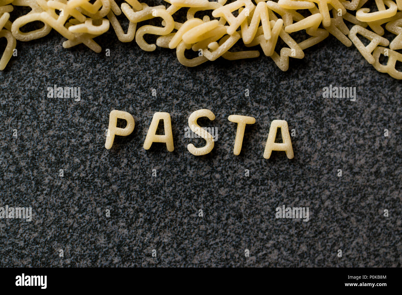 Raw Alphabet Pasta is Written with Letters on Granit Grey Surface ...