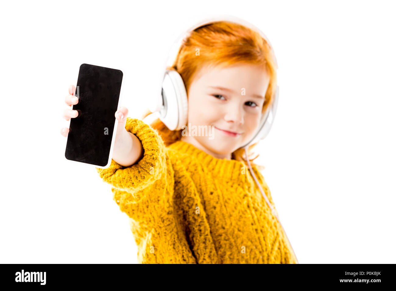 red hair kid showing smartphone isolated on white Stock Photo - Alamy