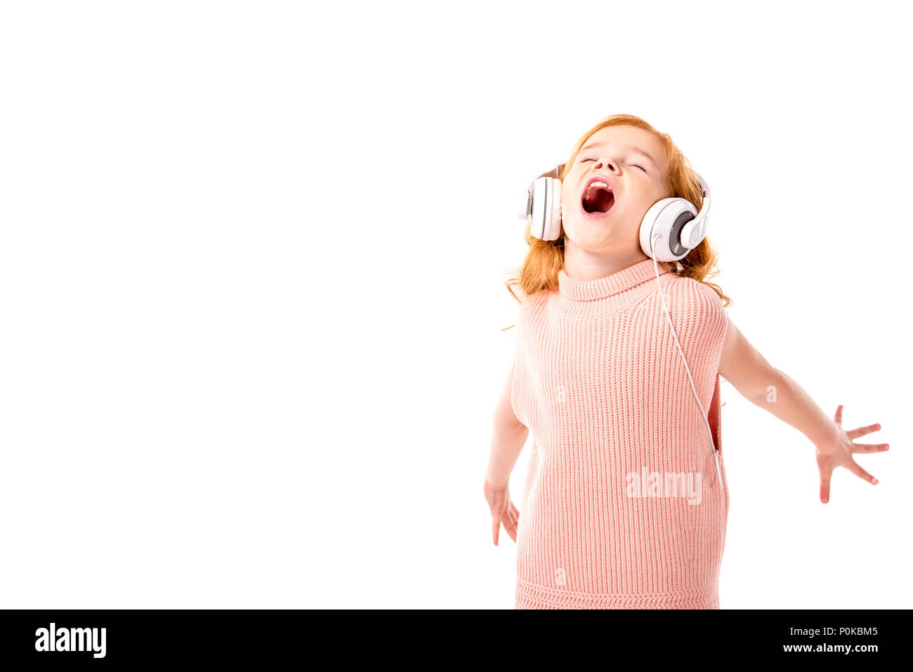 red hair kid in headphones screaming and dancing isolated on white ...
