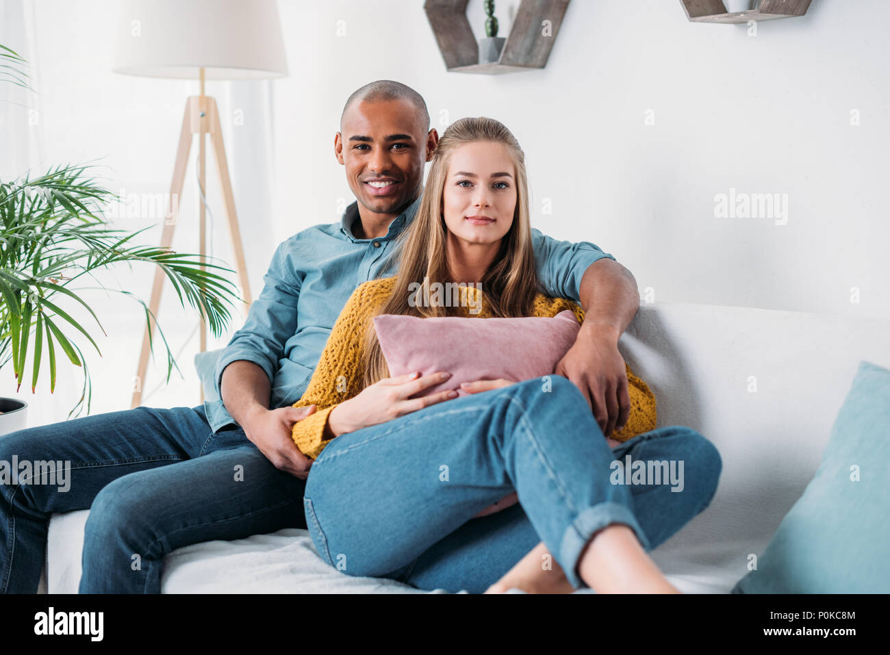 Couple hugging on sofa hi-res stock photography and images - Alamy