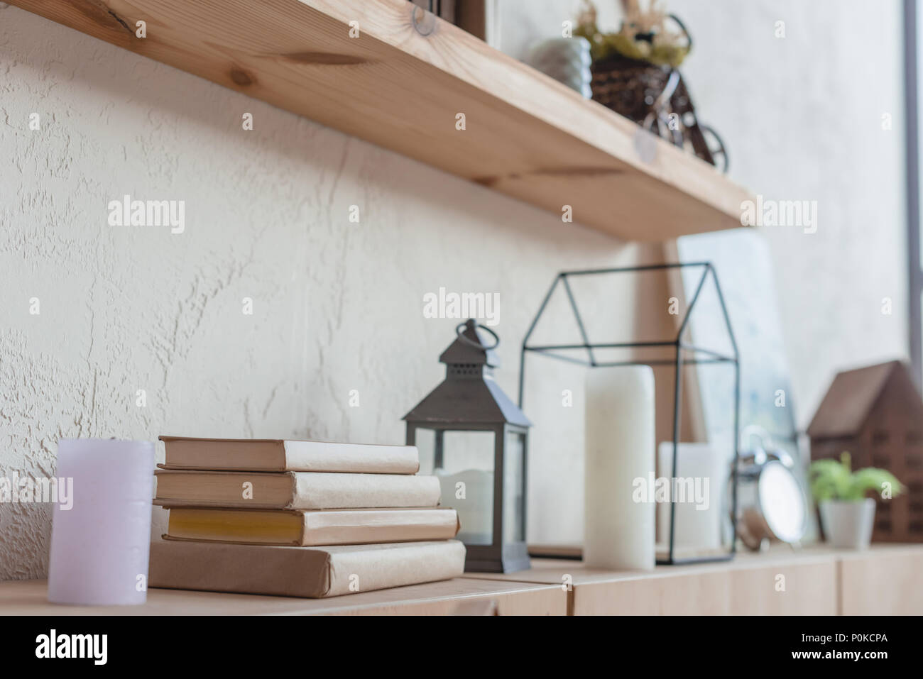 close-up shot of bookshelf with beautiful decorations and stack of ...