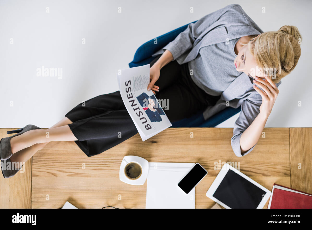 Businesswoman newspaper overhead hi-res stock photography and images ...