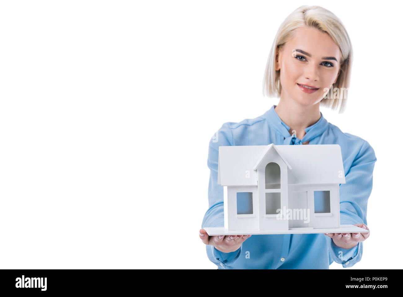 portrait of young real estate agent with house model isolated on white ...