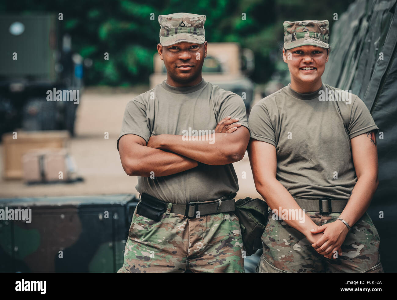 Pfc. Roffes Watson and Pfc. Renee Shaw stand next the the field showers ...