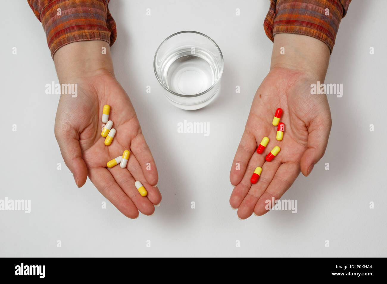 Pill in a hand isolated on white background Stock Photo - Alamy