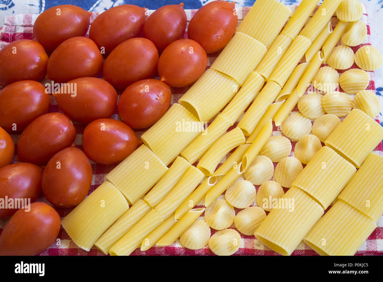 raw assorted pasta with fresh ripe tomatoes Stock Photo - Alamy
