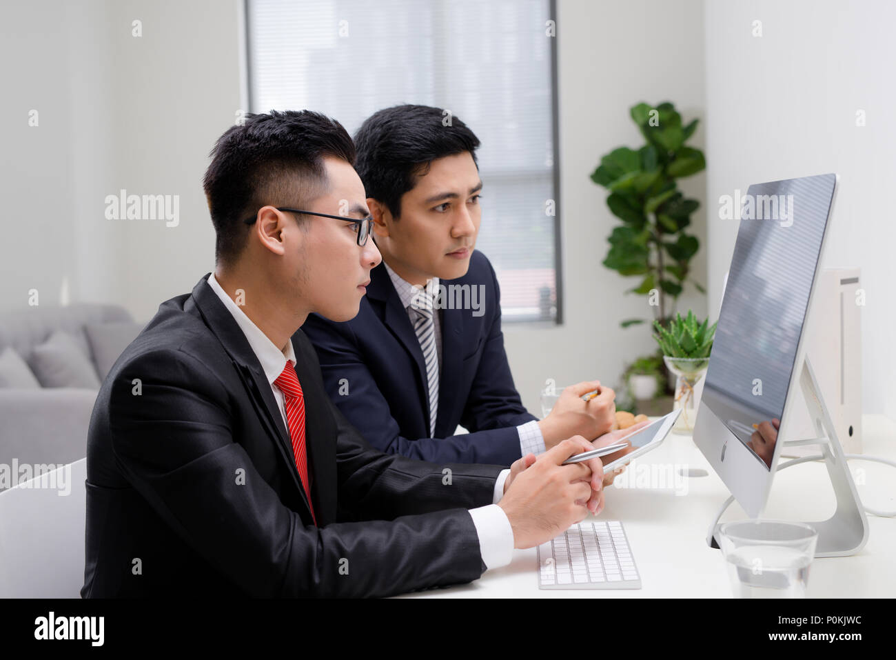Startup business partners working together in desktop Stock Photo - Alamy