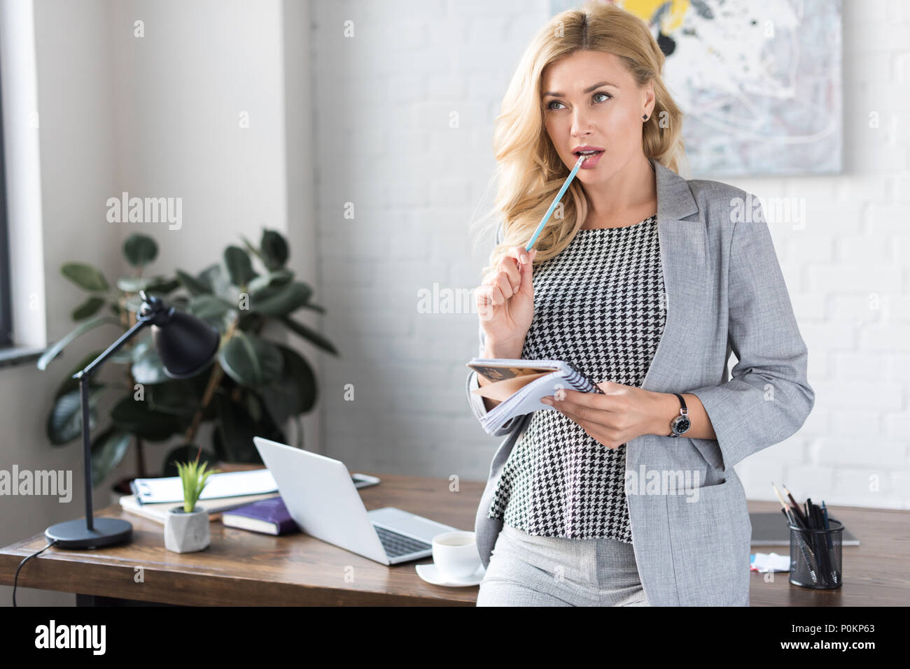 Businesswoman biting pencil hi-res stock photography and images - Alamy