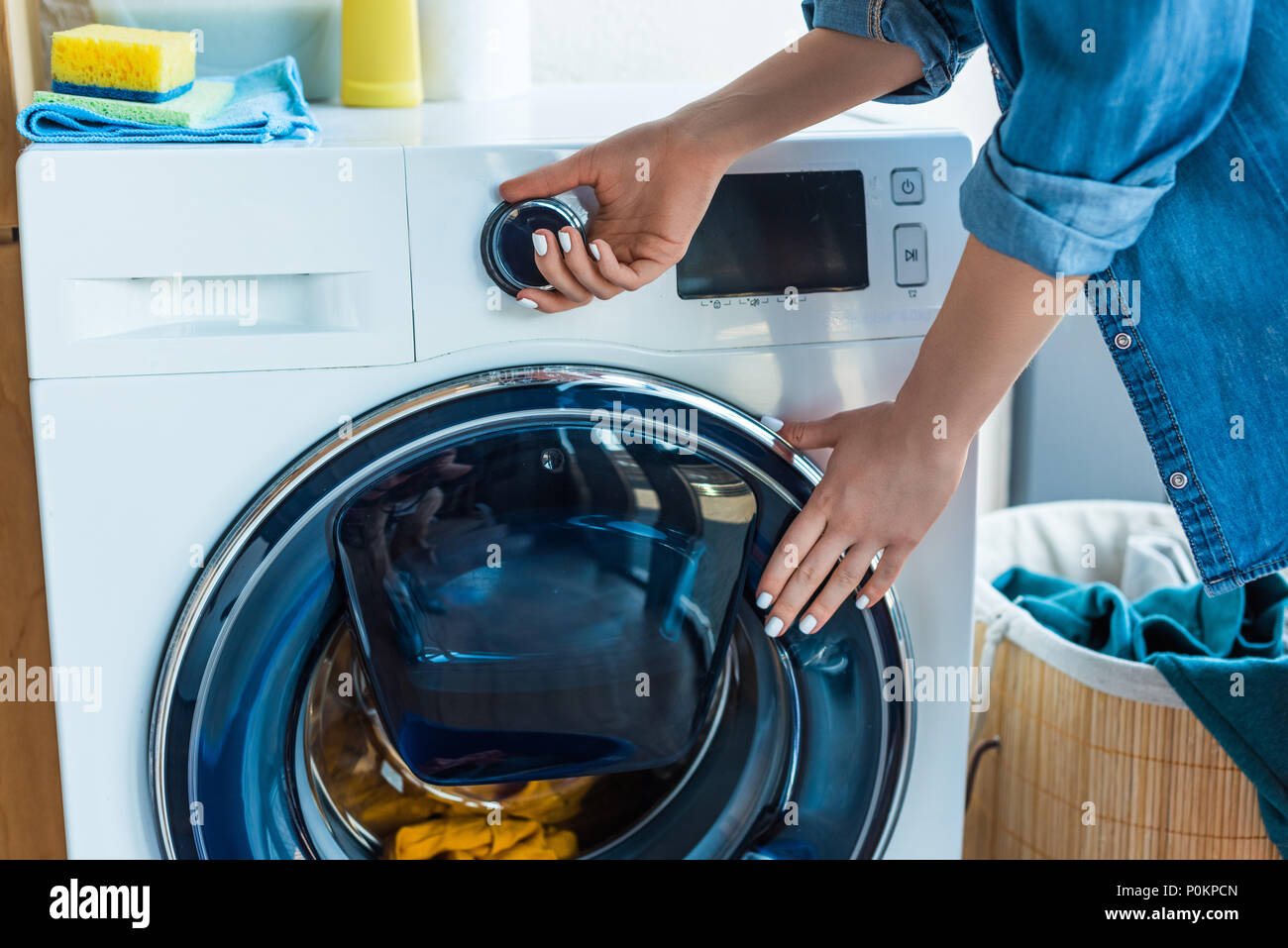 Woman using washing machine hi-res stock photography and images - Alamy