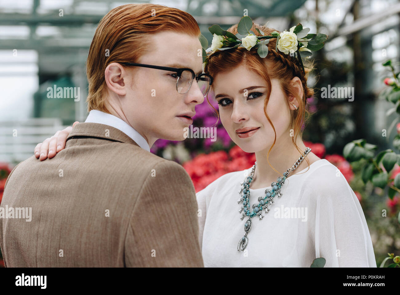 beautiful elegant young red-haired wedding couple standing together in ...