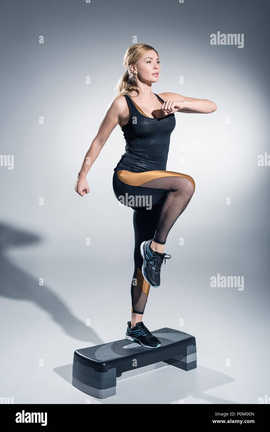 Woman jumping on grey background hi-res stock photography and images ...