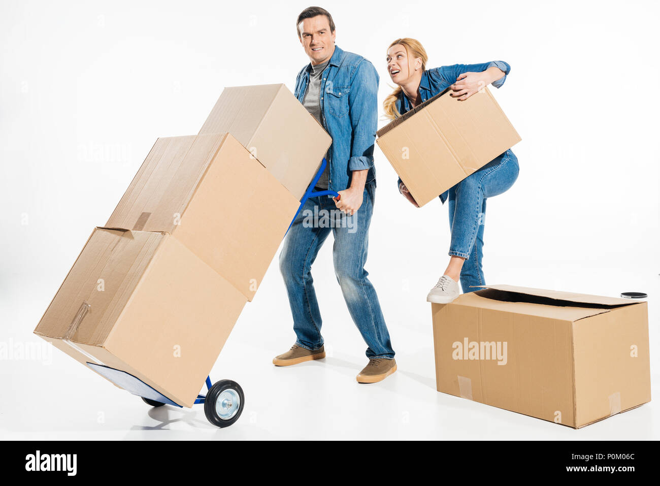 Woman helping man holding trolley cart with cardboard boxes isolated on ...