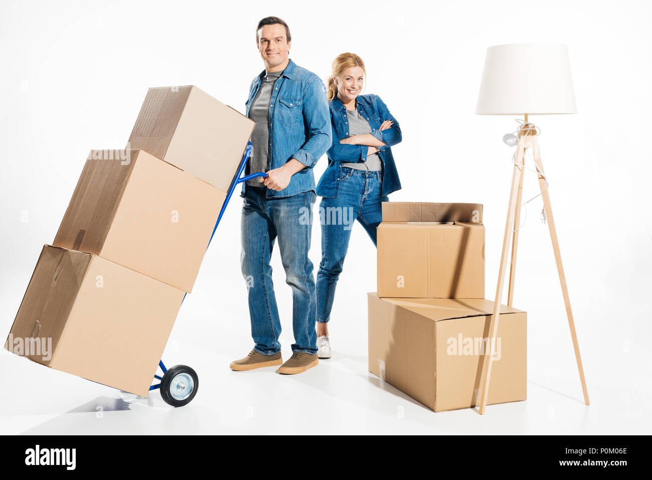 Flat moving concept with woman and man carrying cardboard boxes on ...