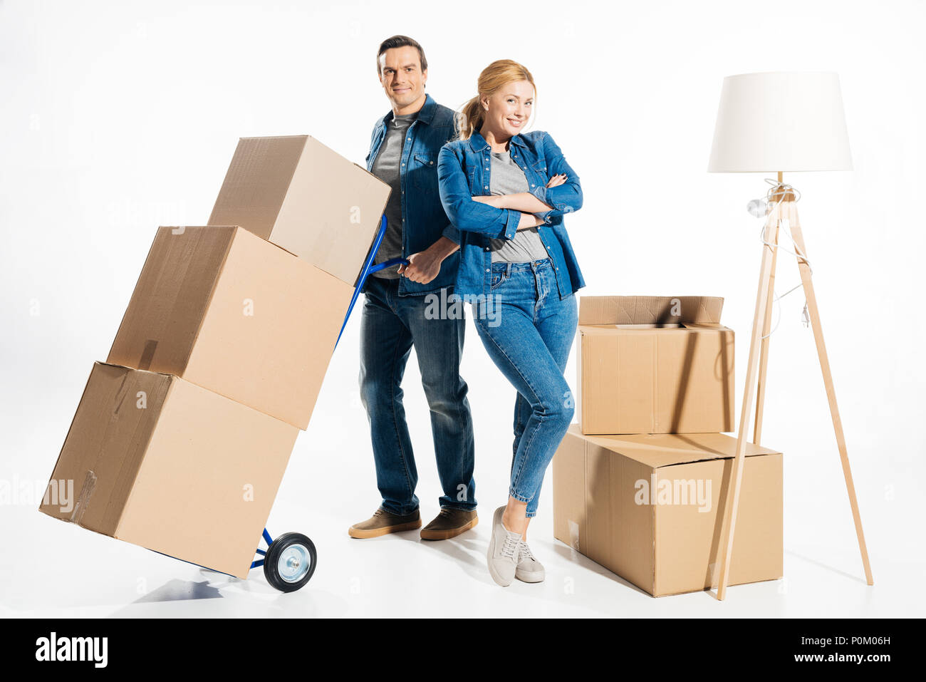 Couple moving cardboard boxes on hand cart isolated on white Stock ...