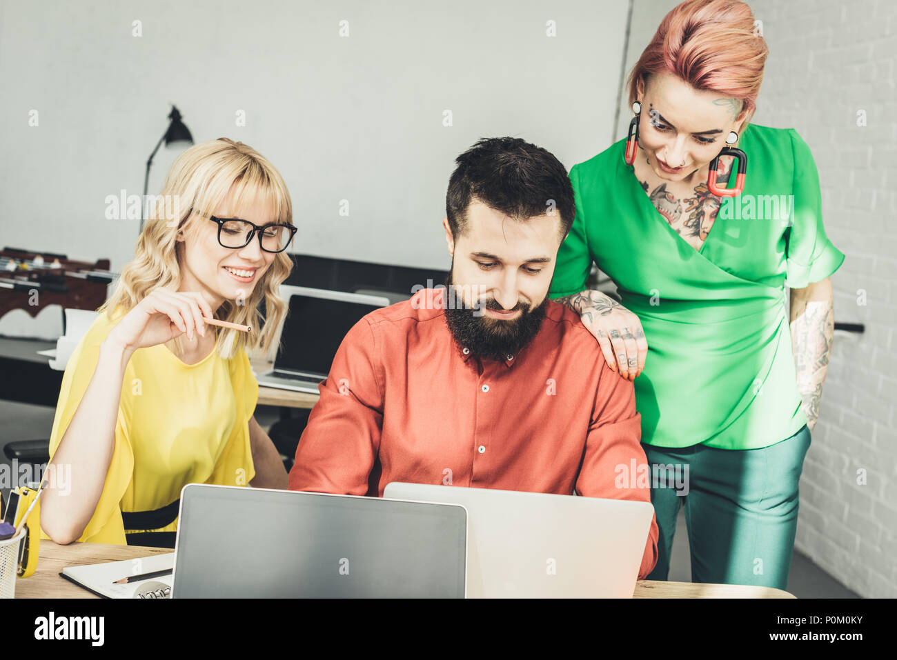 group of young creative workers discussing new project together in ...