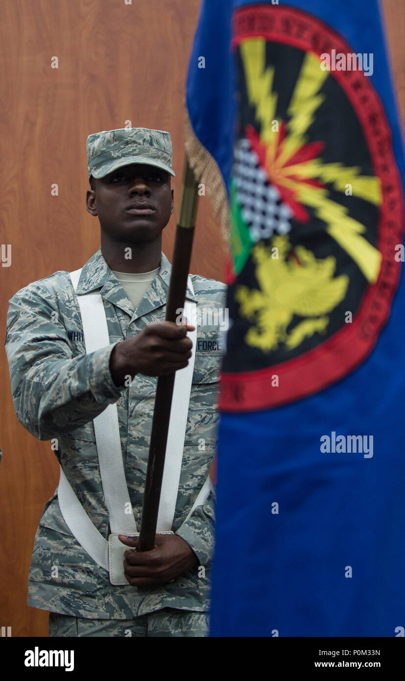 A member of a U.S. Joint Military Honor Guard team posts the colors ...