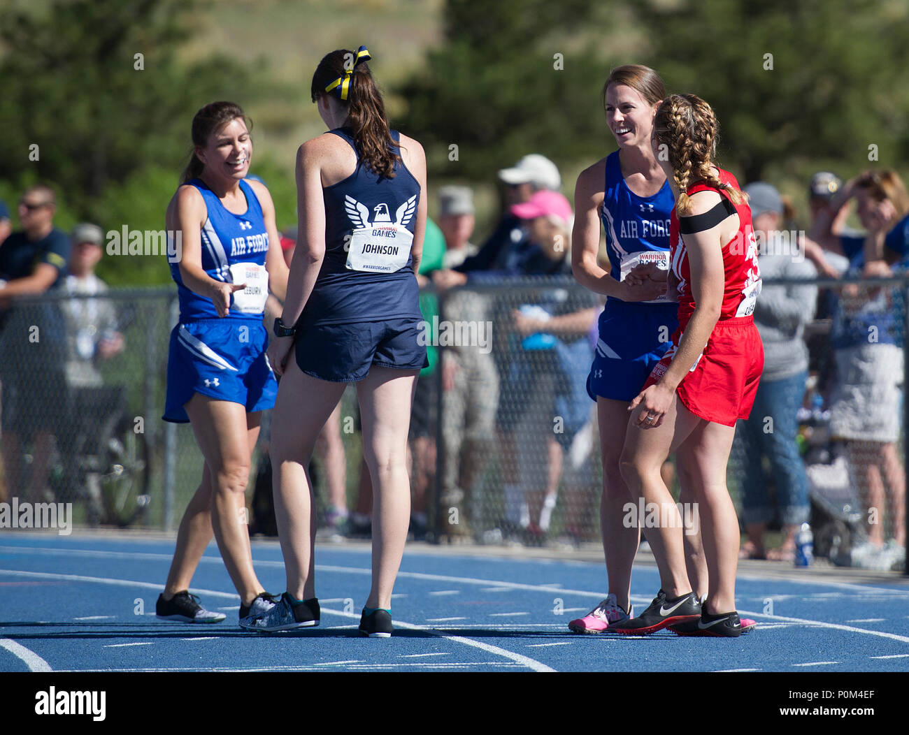 Track athletes talk on the track after finishing the women's 100-meter ...
