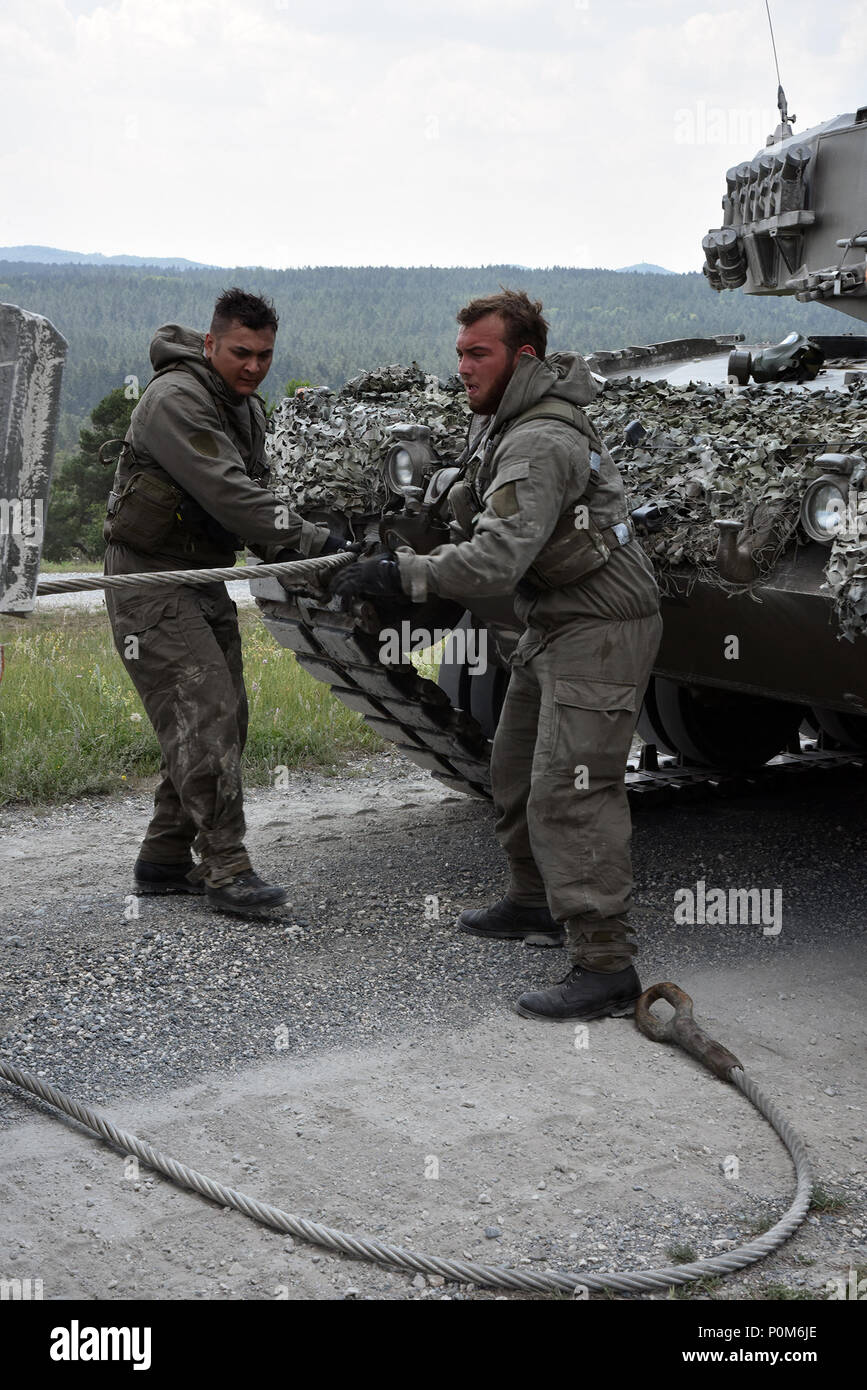 Tankers in Austria’s 6th Tank Company, 14th Panzer Battalion react to a ...