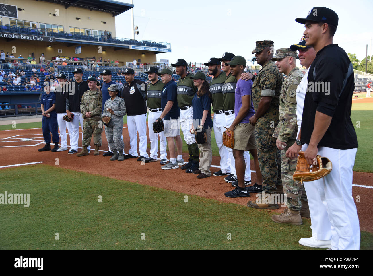 Local military members pose for a group photo with Shuckers baseball ...