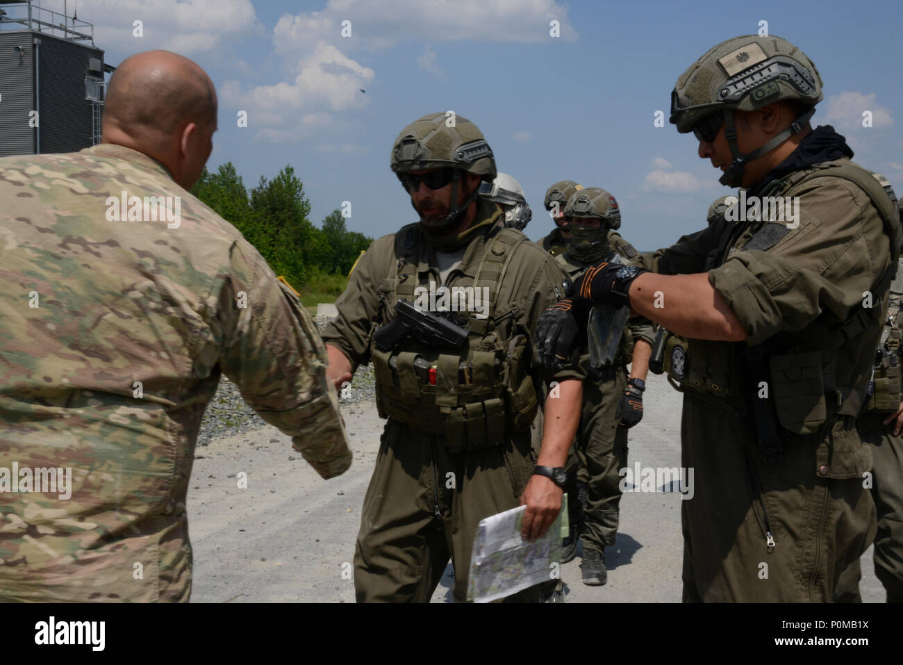 U.S. Army Staff Sgt. Joe Rosas, left, assigned to the Headquarters and ...
