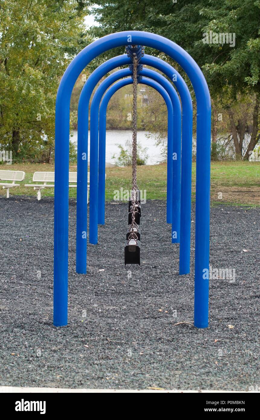 Still blue swings in symmetry Stock Photo - Alamy