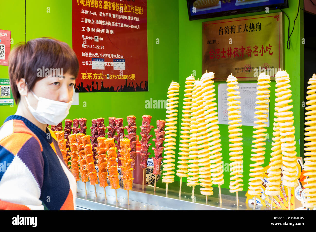 Yangzhou, Jiangsu, China. Young Woman Wearing Breathing Mask at a Stand ...