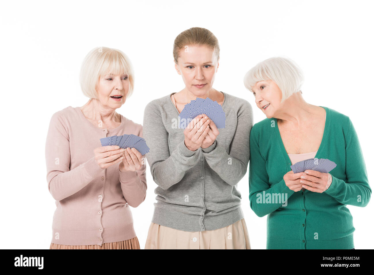Three stylish women playing cards isolated on white Stock Photo - Alamy