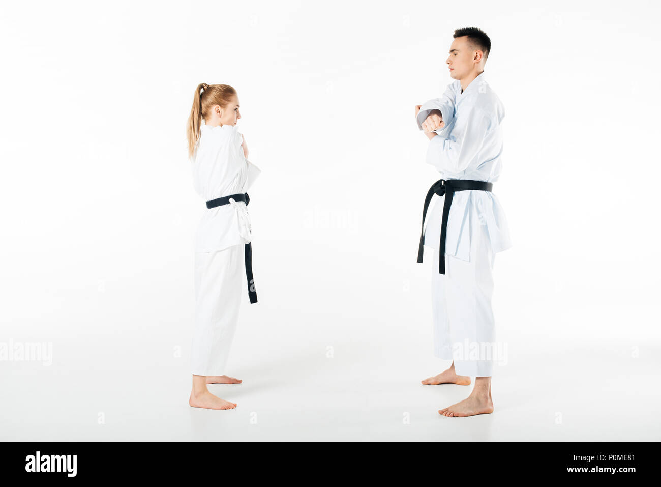 side view of karate fighters stretching hands isolated on white Stock ...
