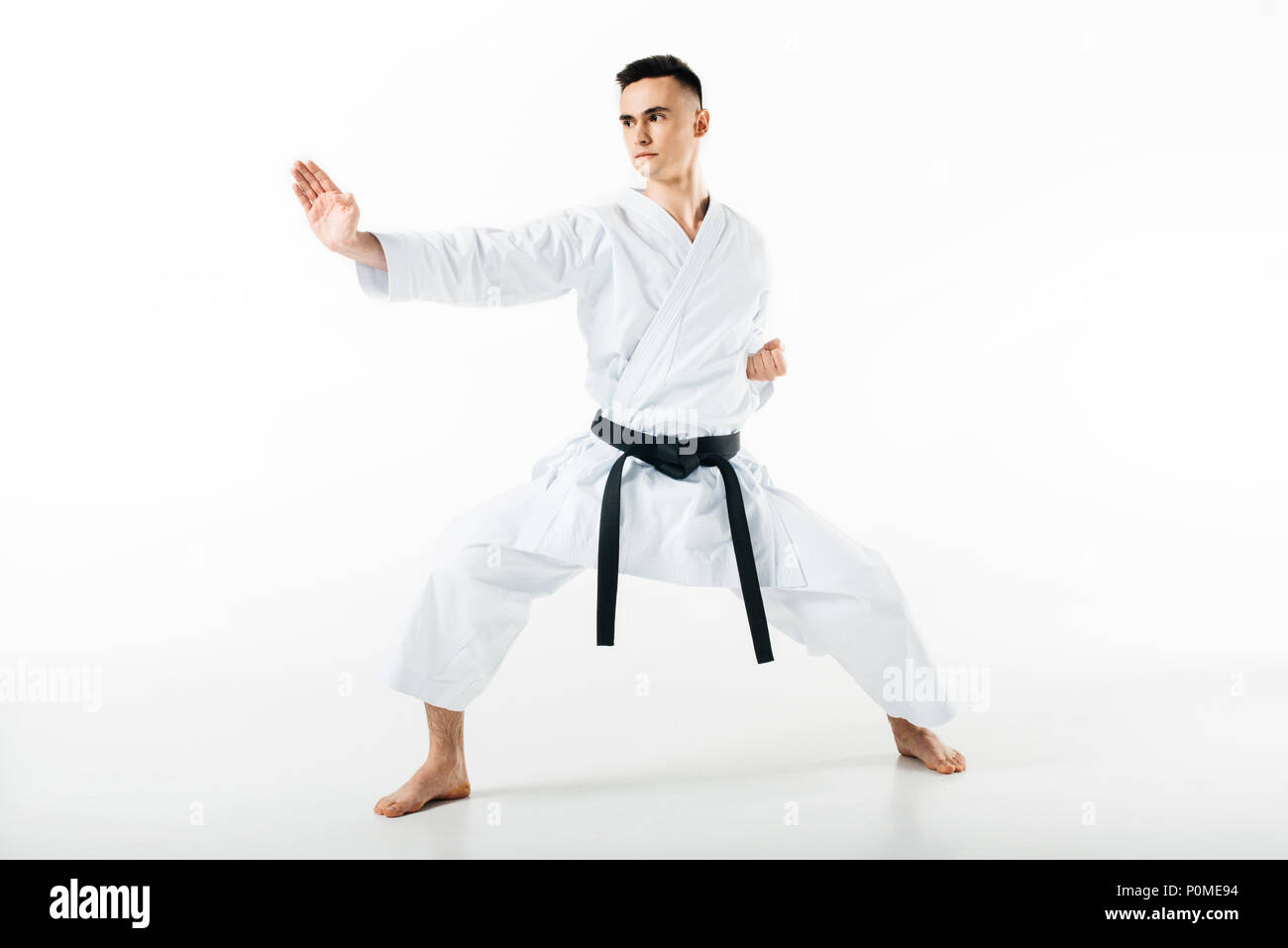 male karate fighter standing in pose isolated on white Stock Photo - Alamy