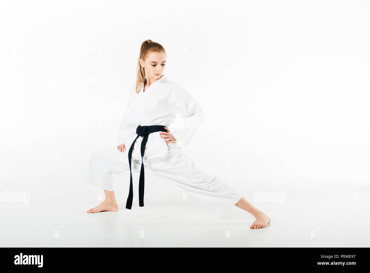female karate fighter stretching legs isolated on white Stock Photo - Alamy
